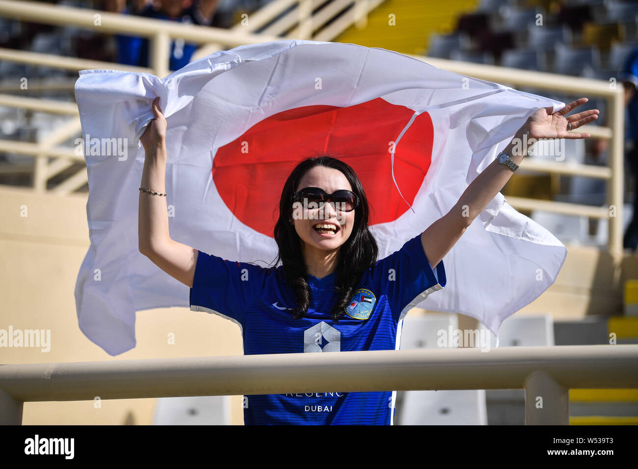 Japanese football fans wave their national flags to show support for ...