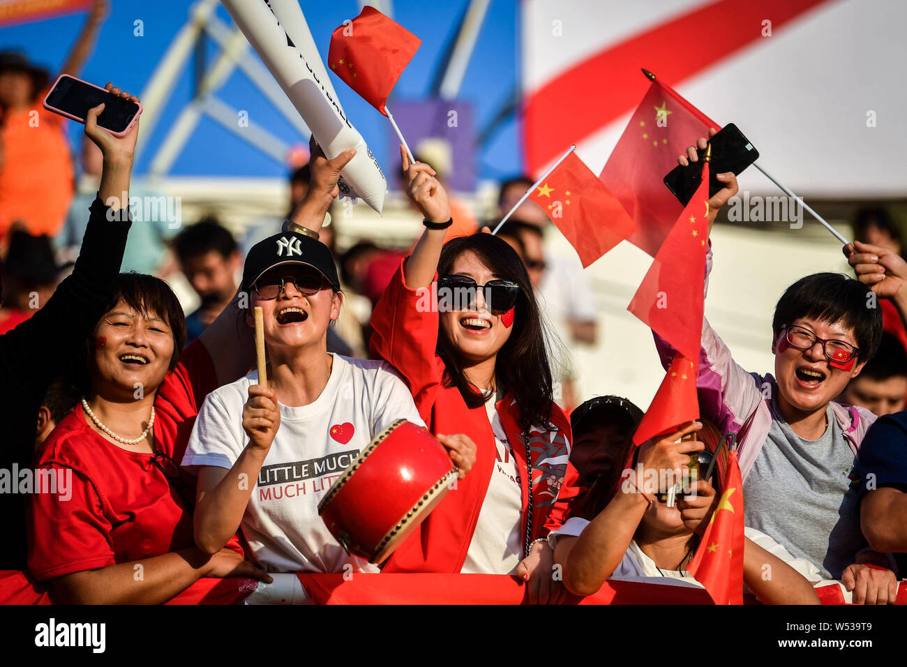 Chinese football fans hold up Chinese national flags to show support ...