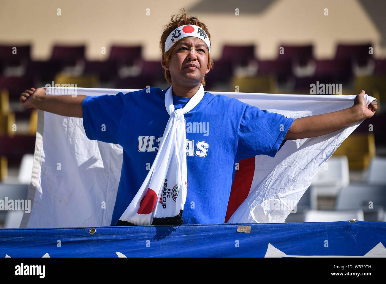 Japanese football fans wave their national flags to show support for ...