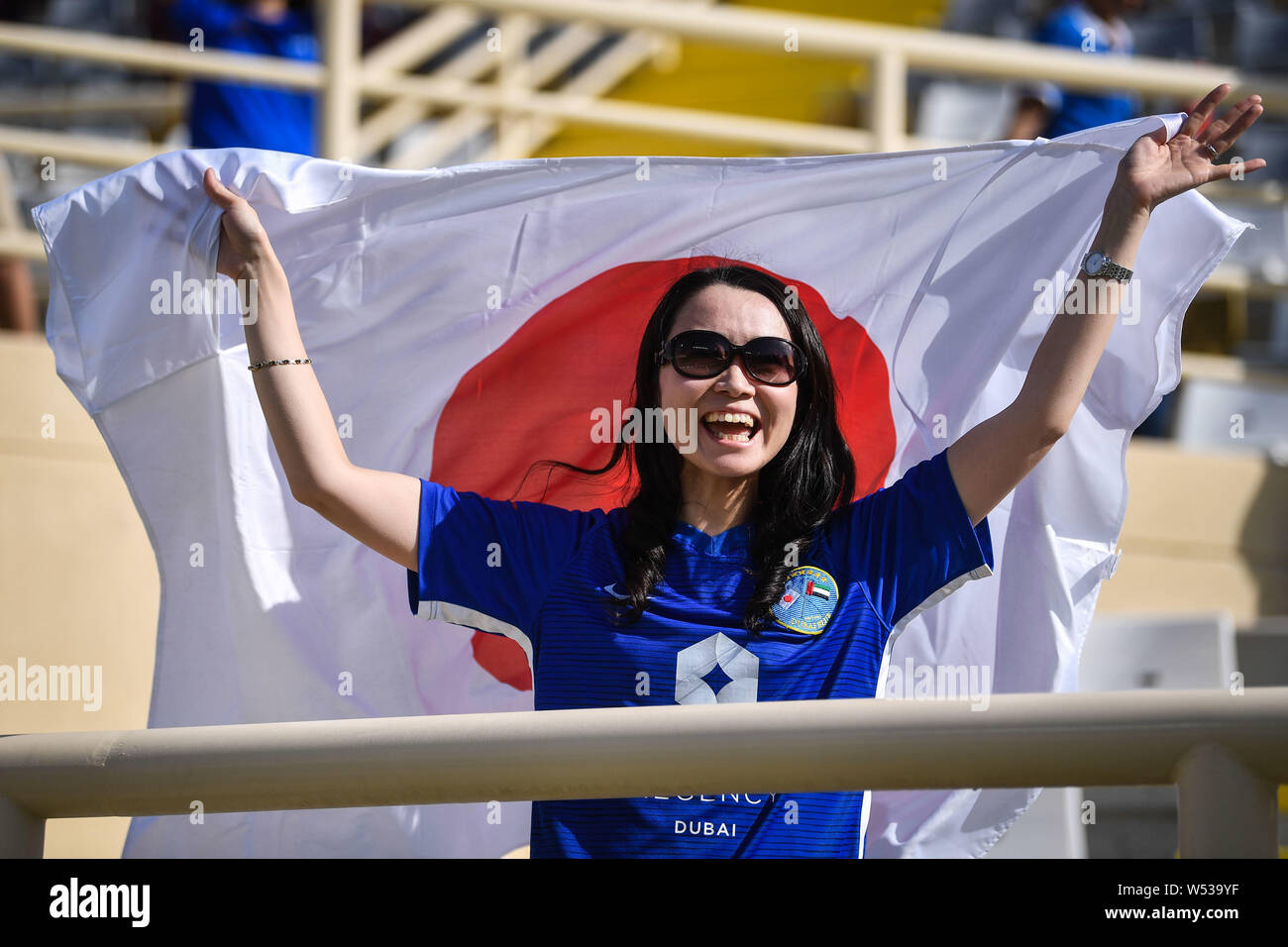 Japanese football fans wave their national flags to show support for ...
