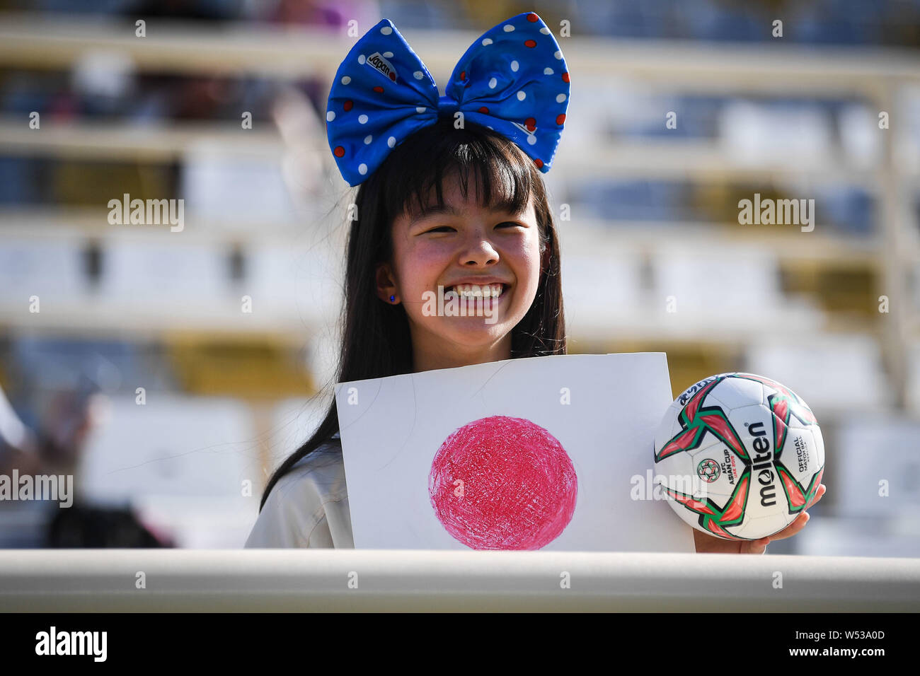 Japanese football fans wave their national flags to show support for ...