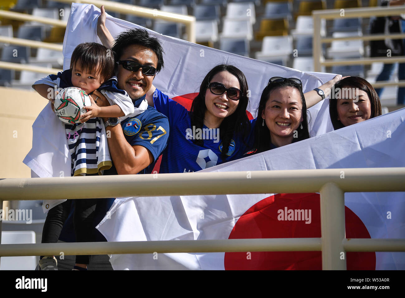 Japanese football fans wave their national flags to show support for ...