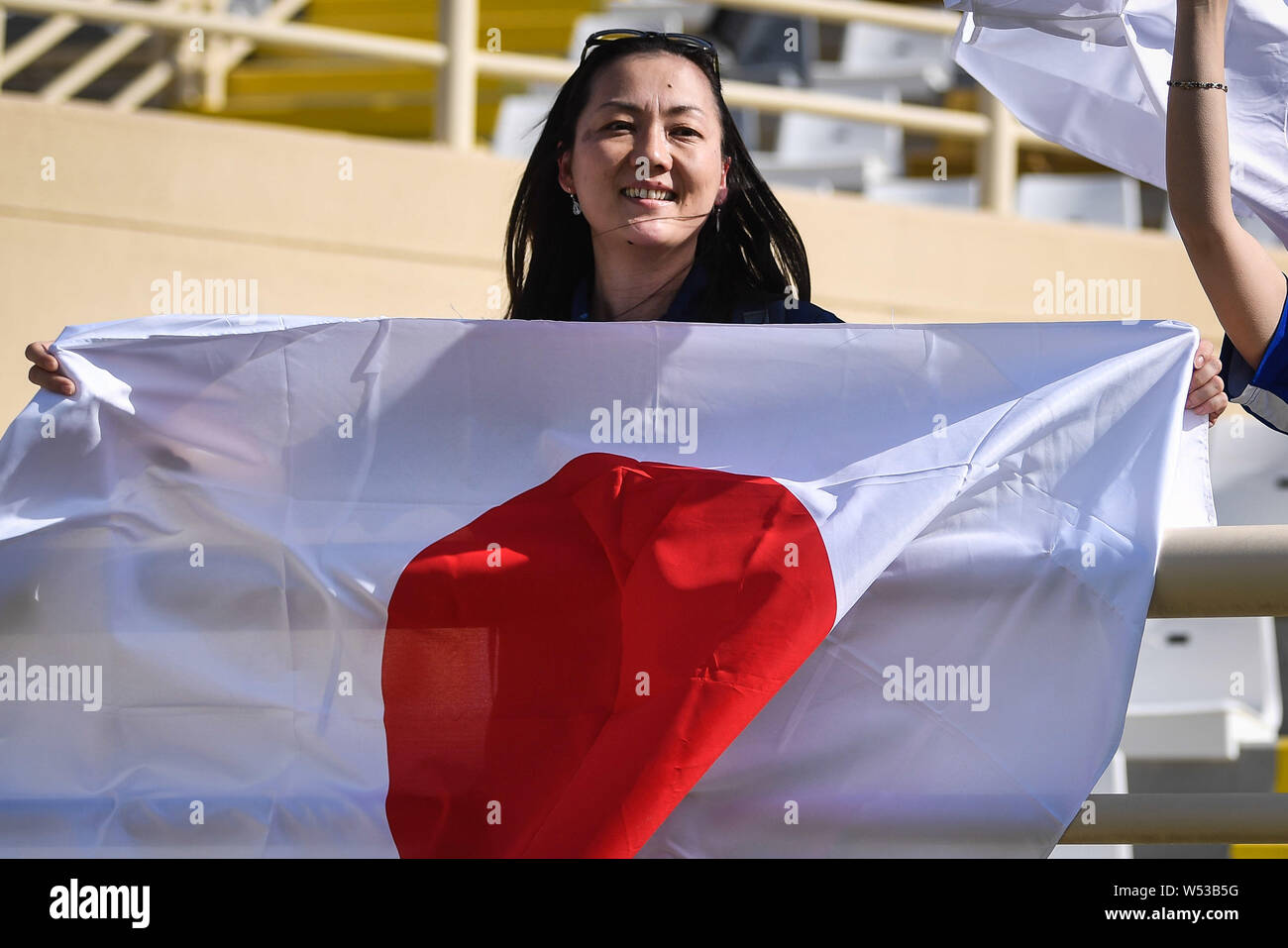Japanese football fans wave their national flags to show support for ...