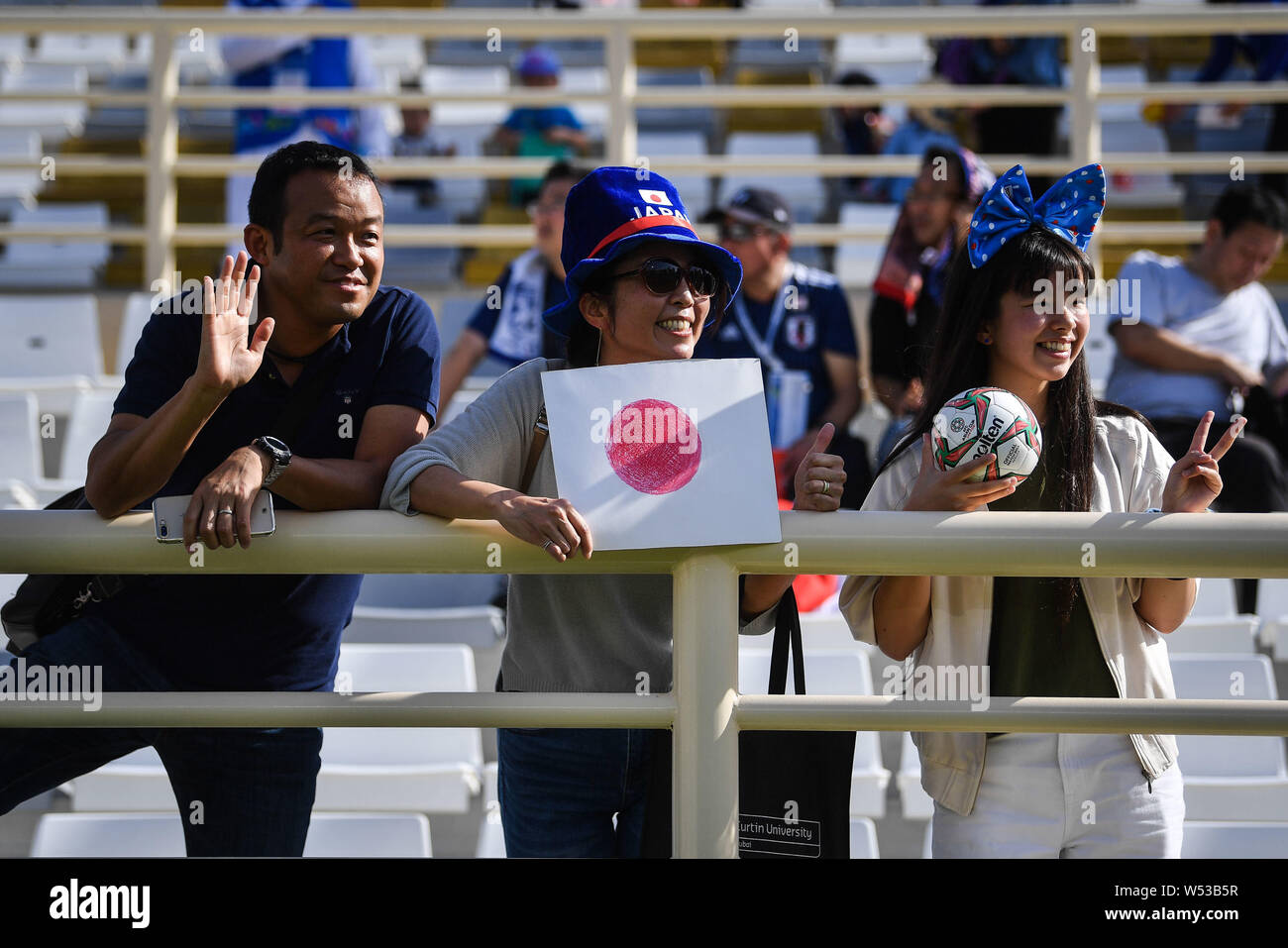 Japanese football fans wave their national flags to show support for ...