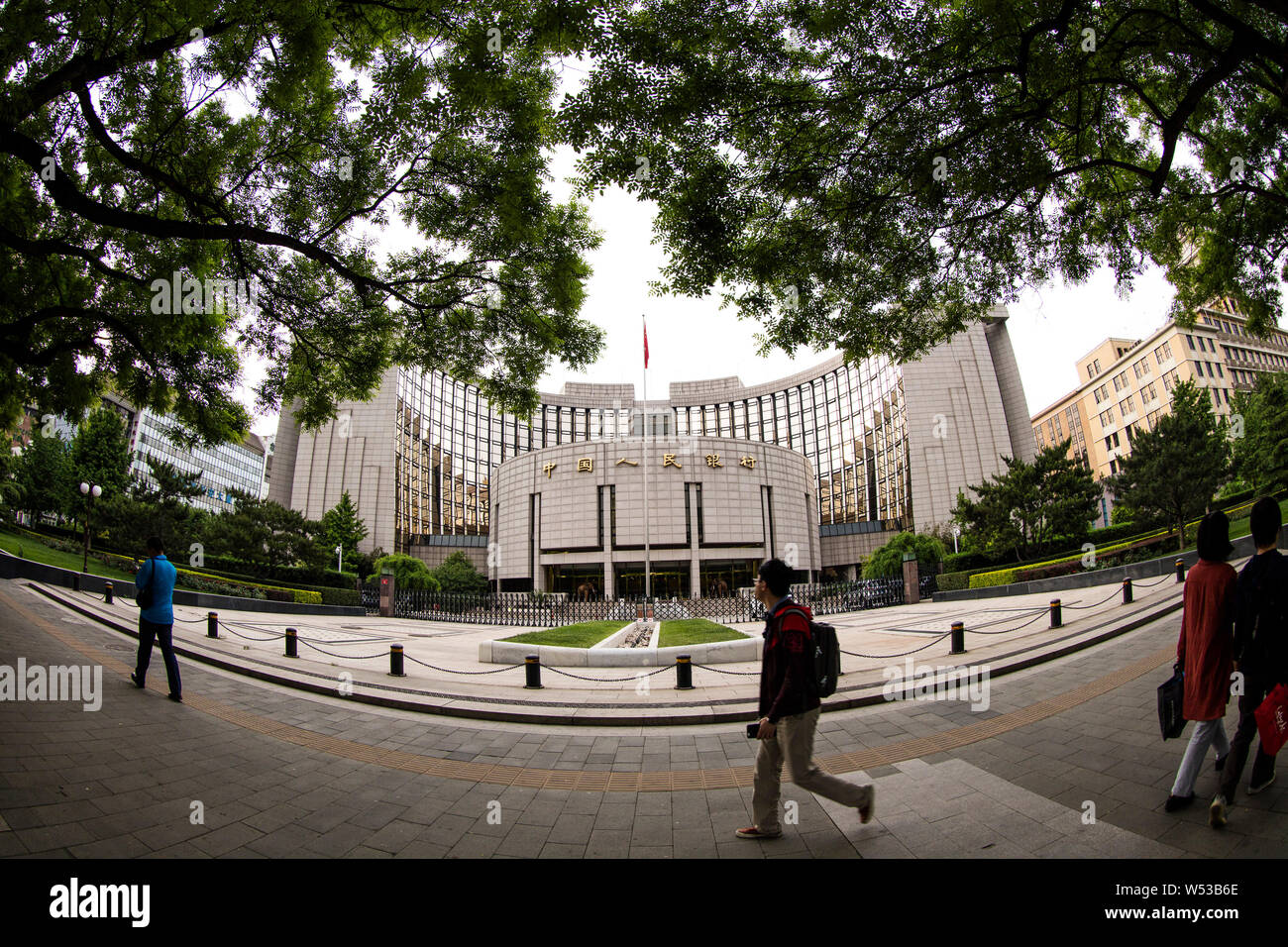 --FILE--Pedestrians walk past the headquarters and head office of the ...