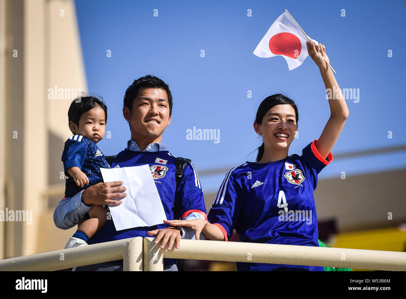 Japanese football fans wave their national flags to show support for ...