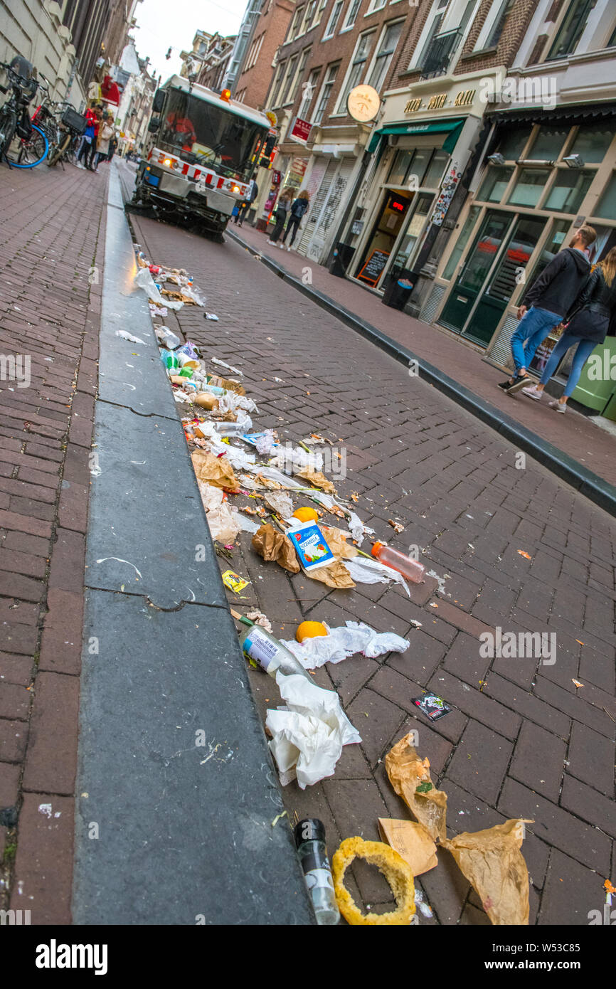 Road sweeper sweeping rubbish up from a bike lane in the Dutch city of ...