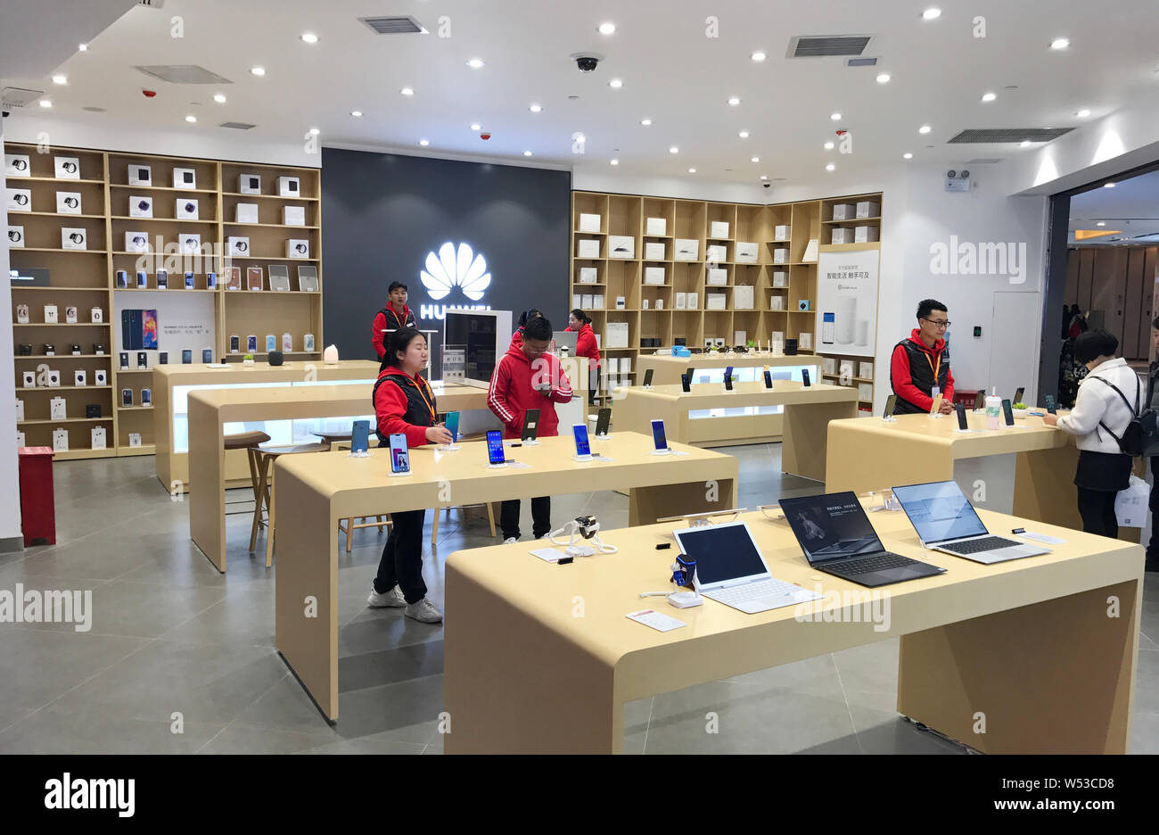 --FILE--Chinese employees are seen at a store of Huawei at a shopping ...
