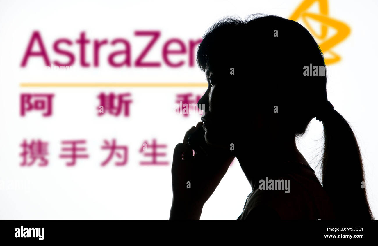 --FILE--A pedestrian walks past an advertisement for AstraZeneca in ...