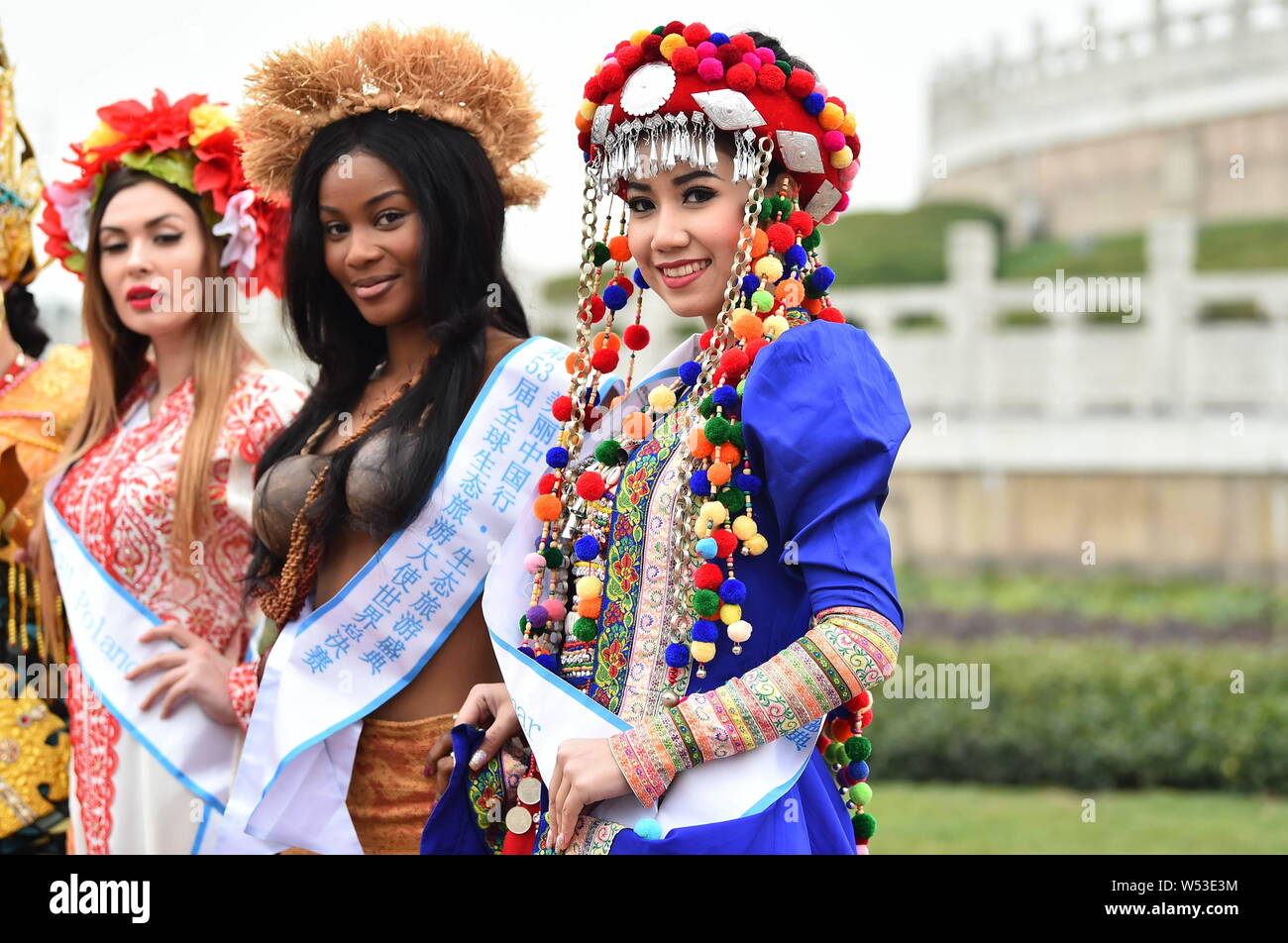 Contestants dressed in traditional costumes take part in an outdoor ...