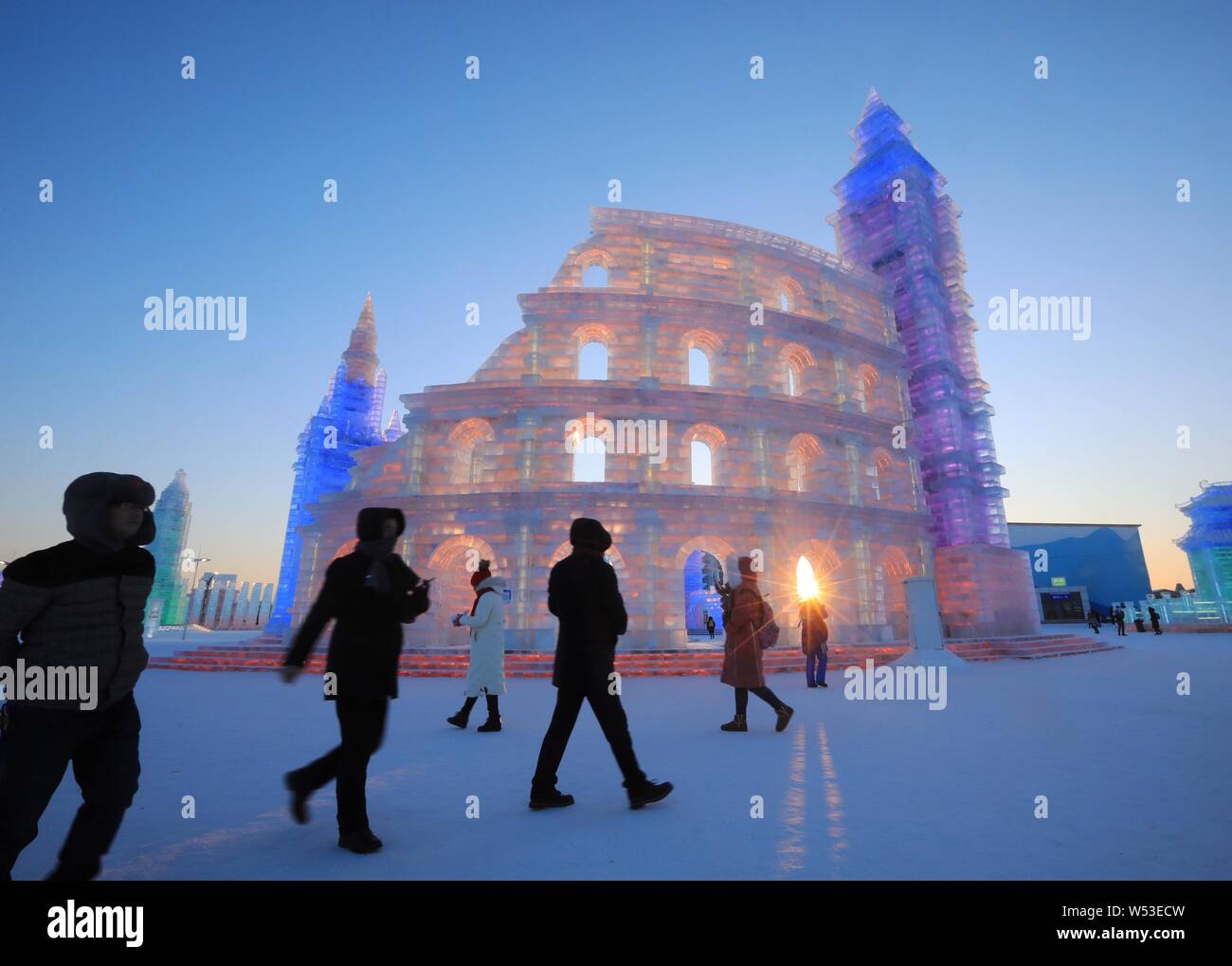Visitors walk past a downsized ice replica of part of The Colosseum at ...