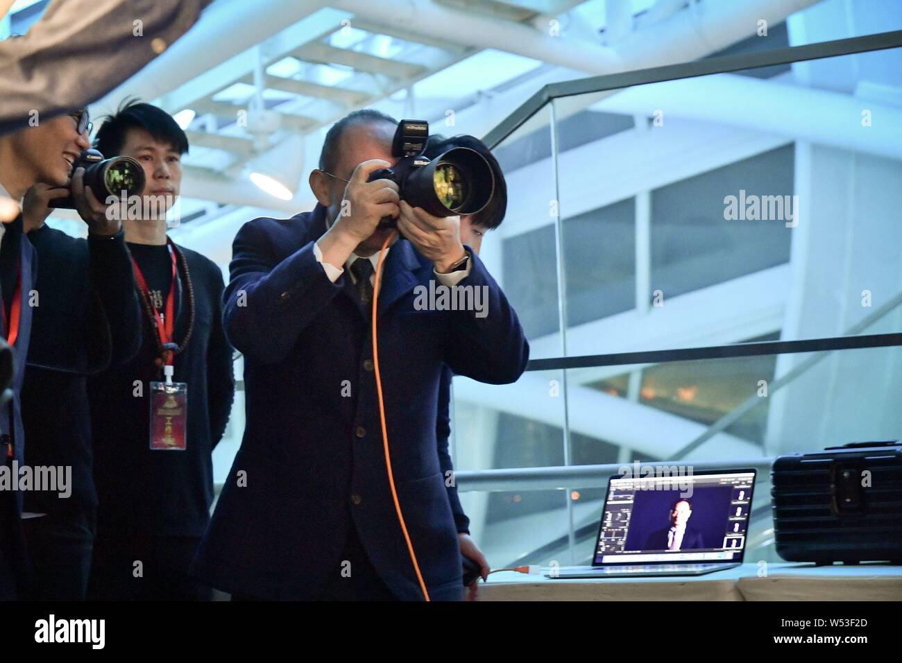 Pan Shiyi, co-founder, Chairman and co-CEO of SOHO China, takes photos ...