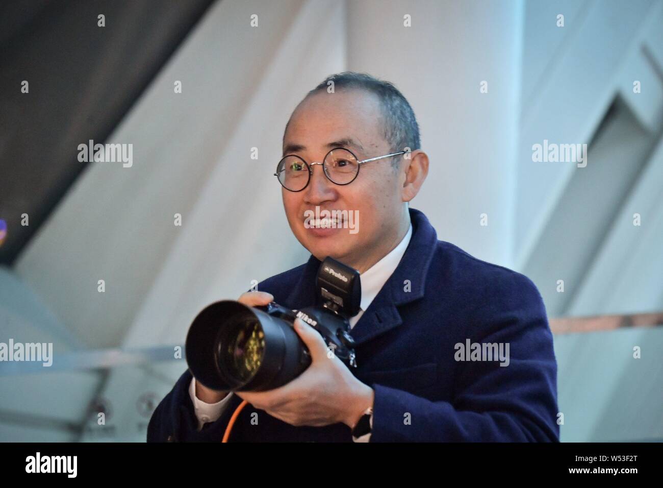 Pan Shiyi, co-founder, Chairman and co-CEO of SOHO China, takes photos ...