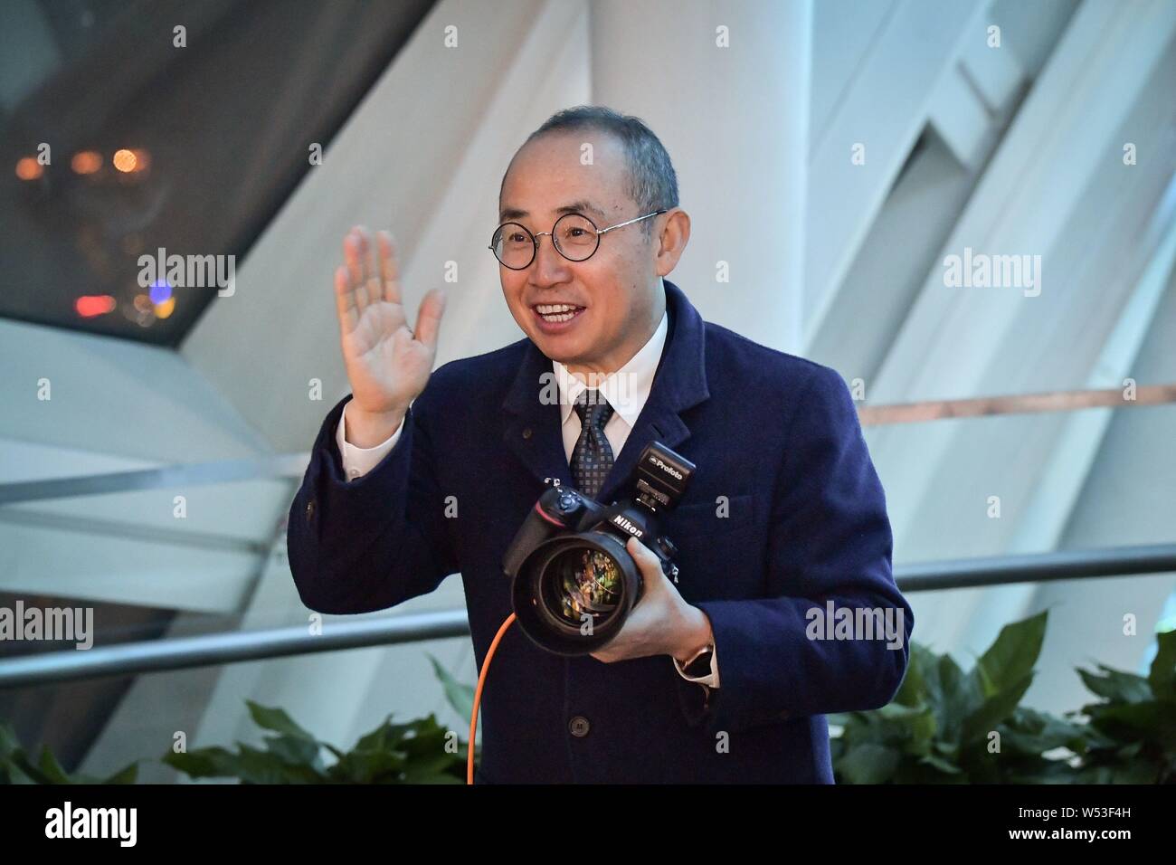 Pan Shiyi, co-founder, Chairman and co-CEO of SOHO China, takes photos ...