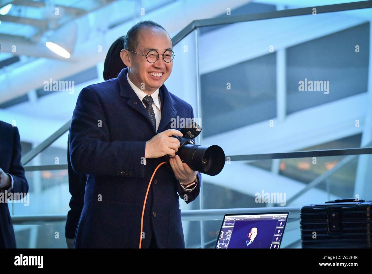 Pan Shiyi, co-founder, Chairman and co-CEO of SOHO China, takes photos ...