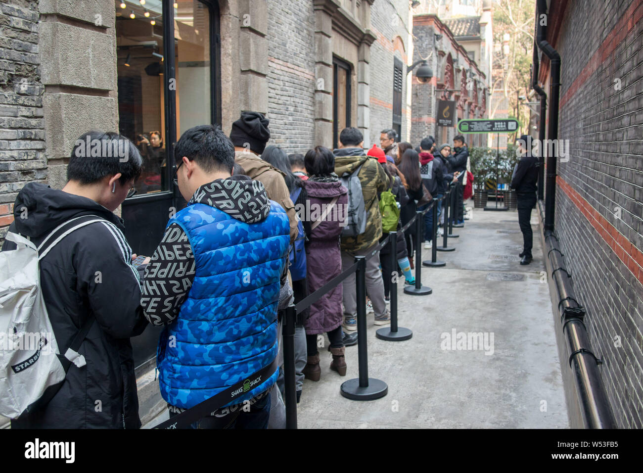 Customers queue up in front of China's first branch Shake Shack at the ...