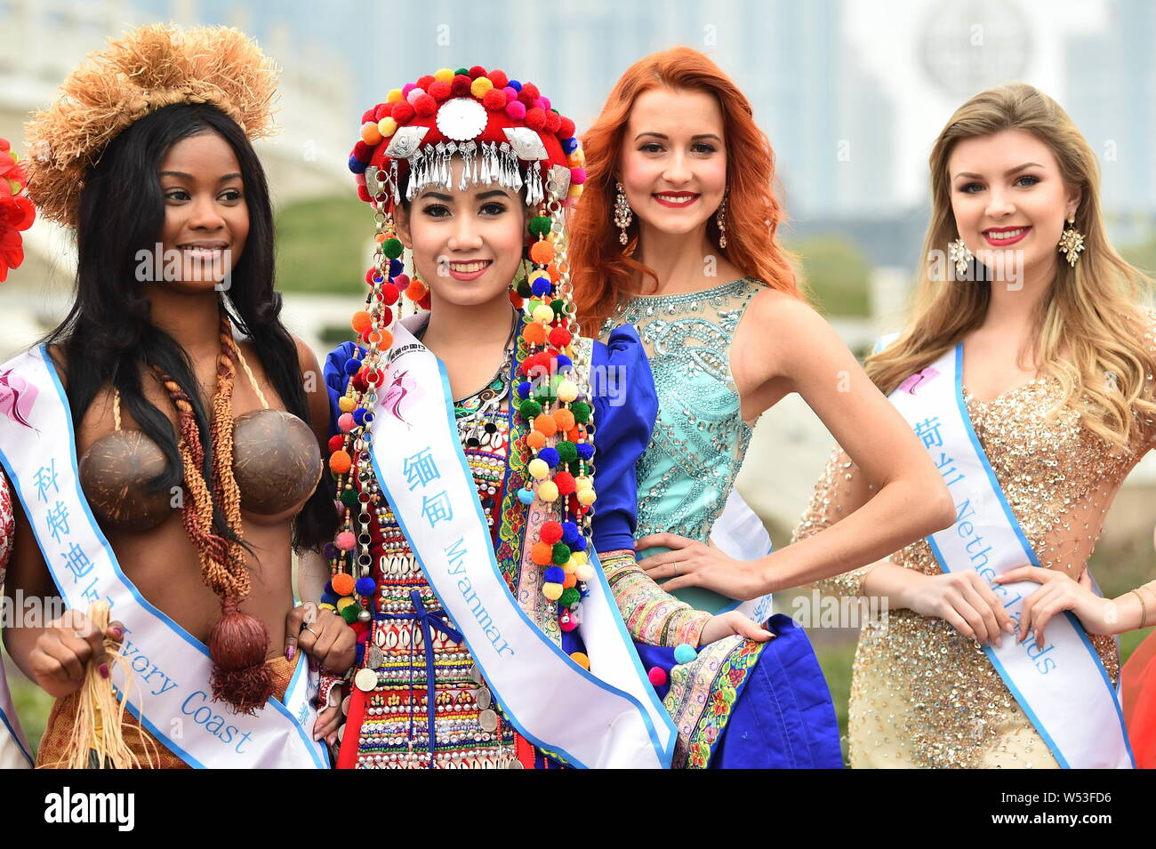 Contestants clad in traditional costumes or evening dresses take part ...
