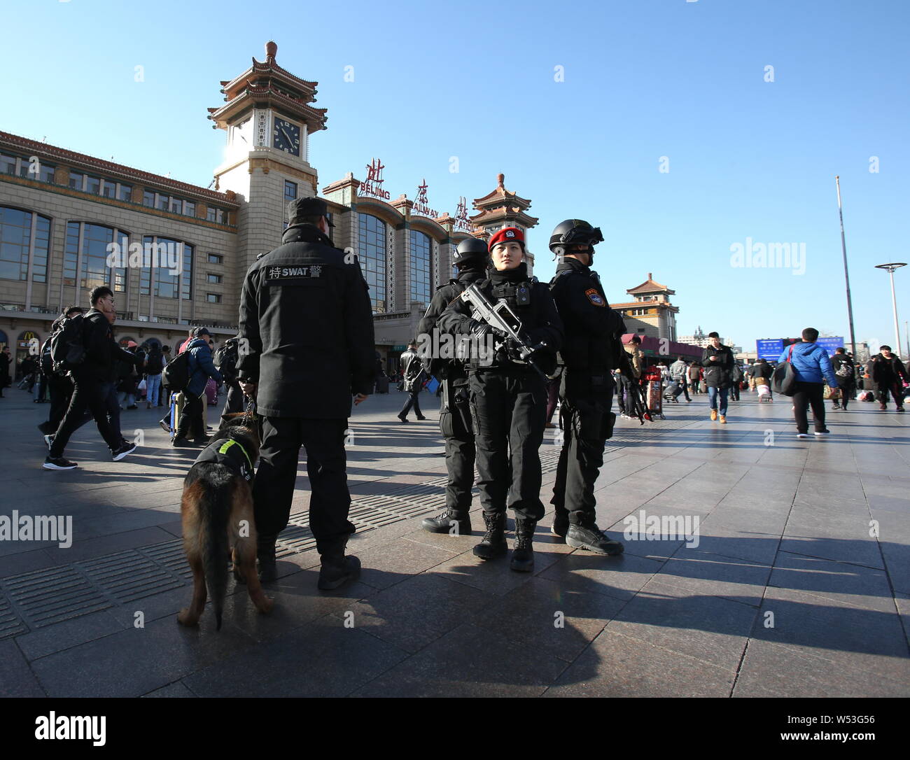 Armed Chinese police officers patrol the square in front of the Beijing ...