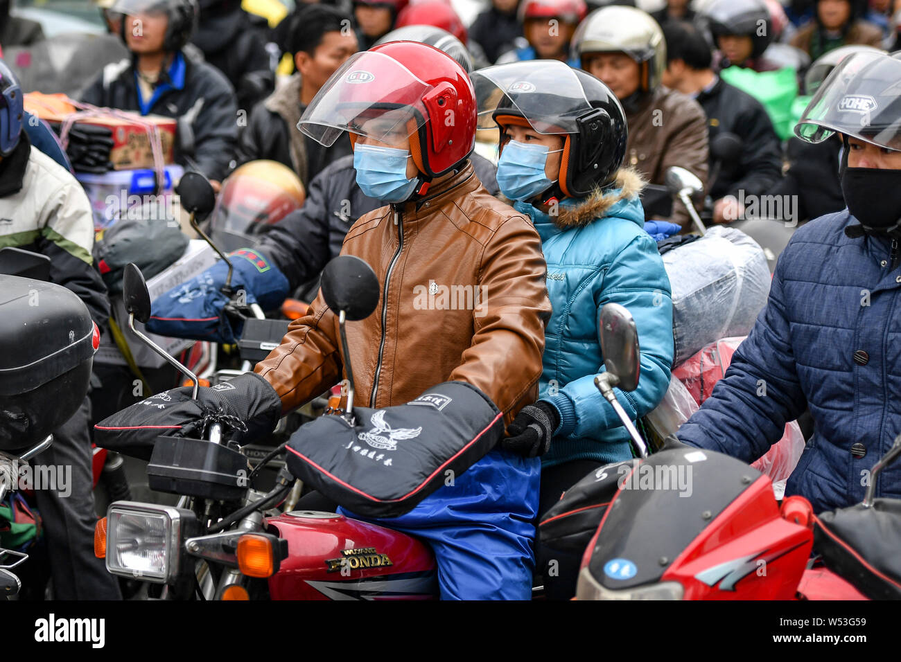 Chinese migrant workers queue up to have their motorcycles to be ...