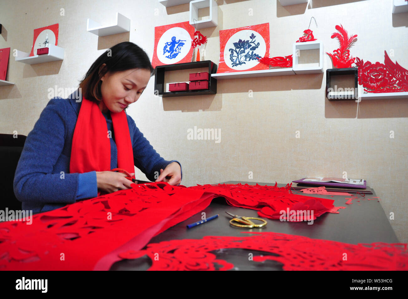 Chinese craftswoman Liang Ying displays cheongsam (qipao) made of paper ...
