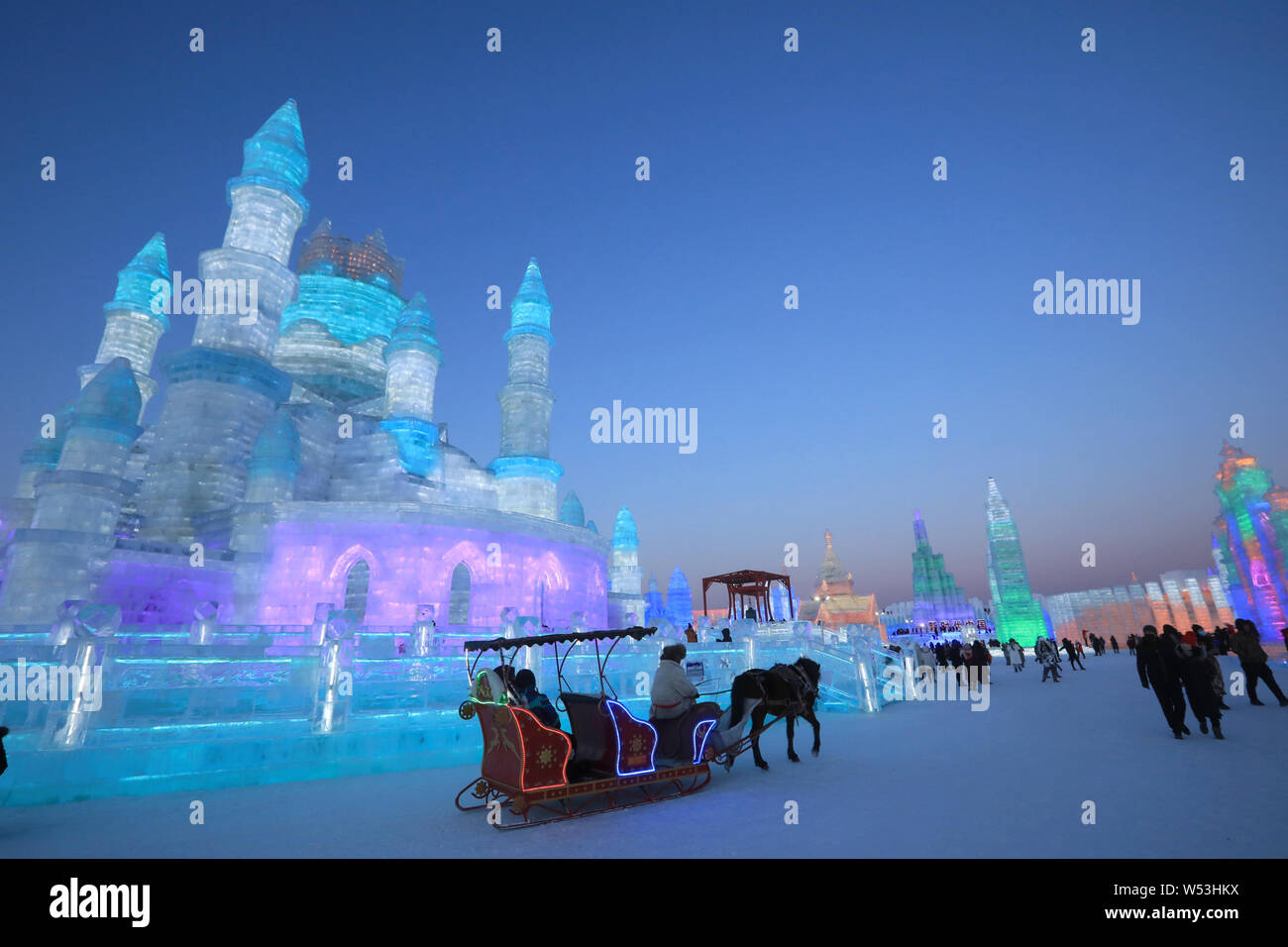 Visitors view ice sculptures on display during 20th China Harbin Ice ...