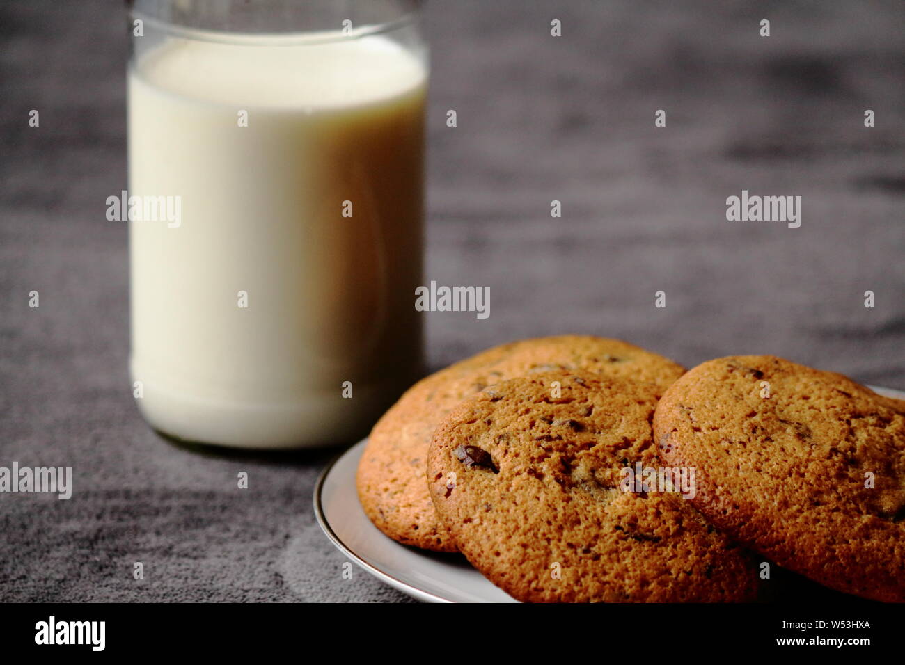 cookies with milk dark grey moody Stock Photo - Alamy