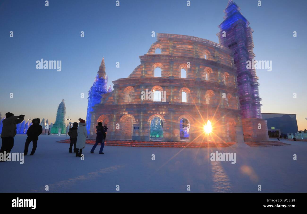 Visitors take pictures or view a downsized ice replica of part of The ...