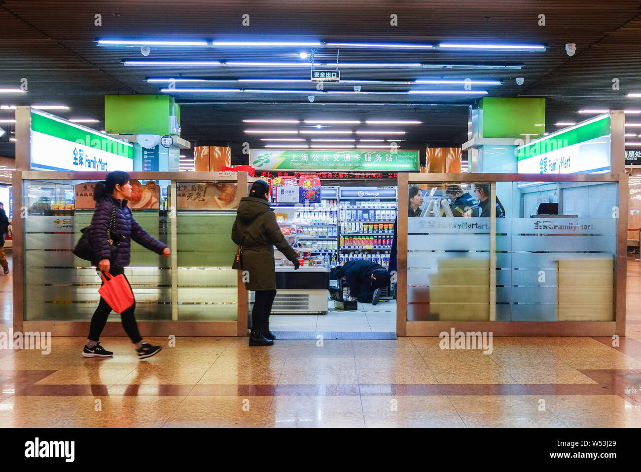 Customers enter the convenience store of FamilyMart at the Jing'an ...
