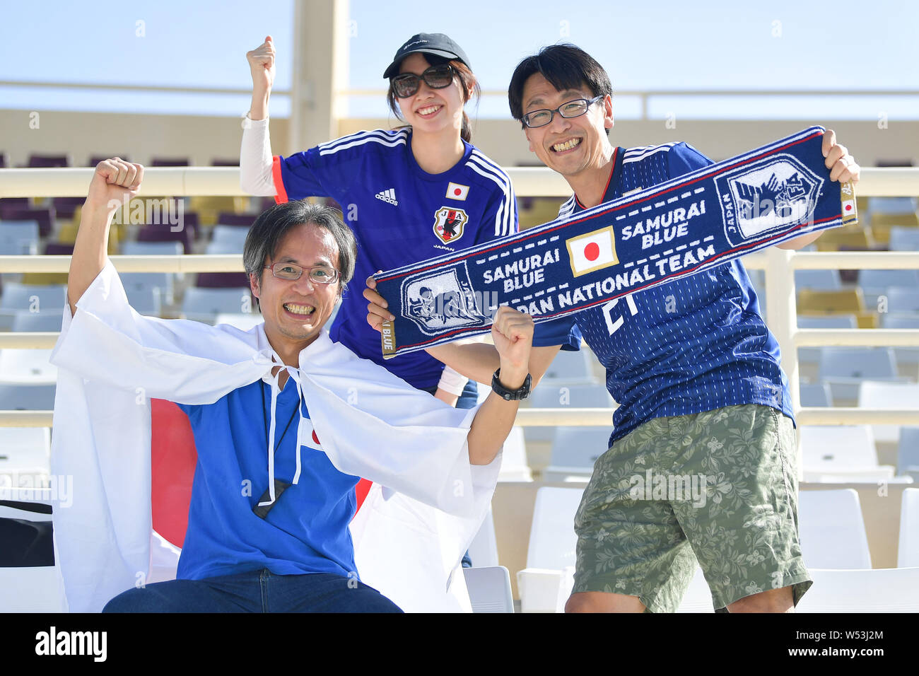 Japanese football fans wave their national flags to show support for ...
