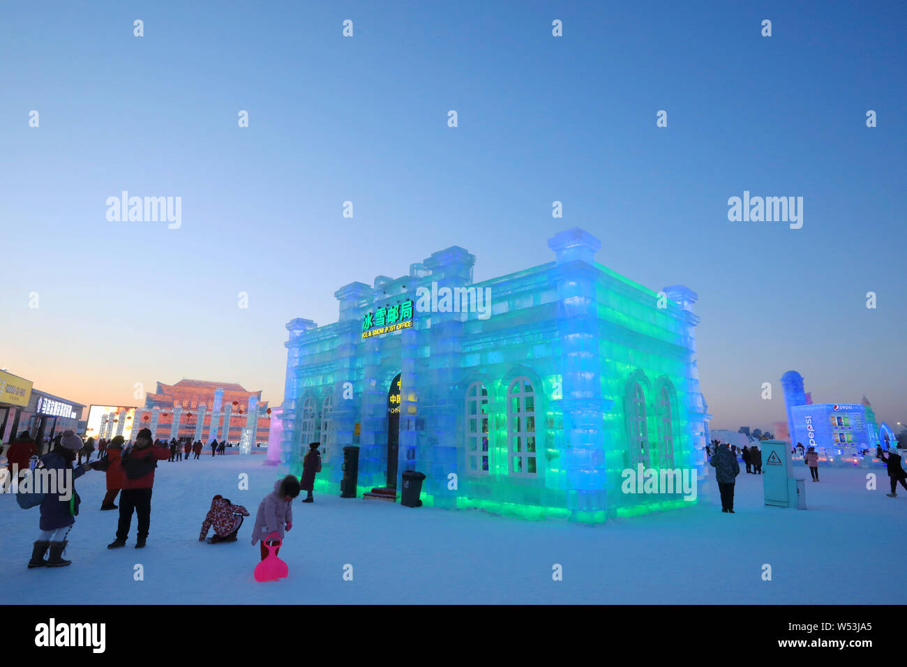 Visitors view ice sculptures on display during 20th China Harbin Ice ...