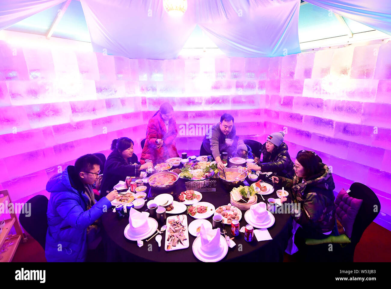 Customers dine in an ice house built with a total ice blocks at a ...