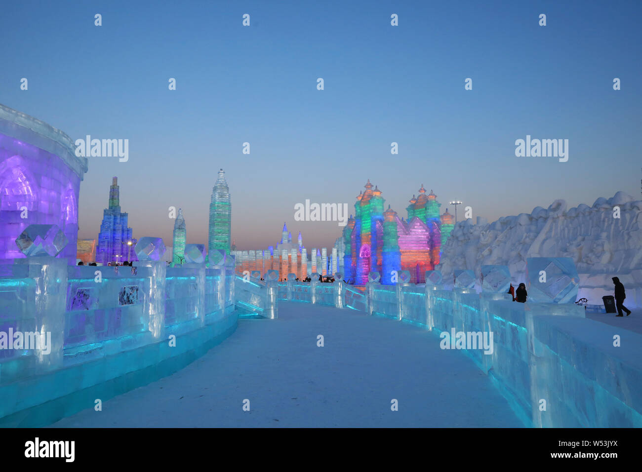 Visitors view ice sculptures on display during 20th China Harbin Ice ...