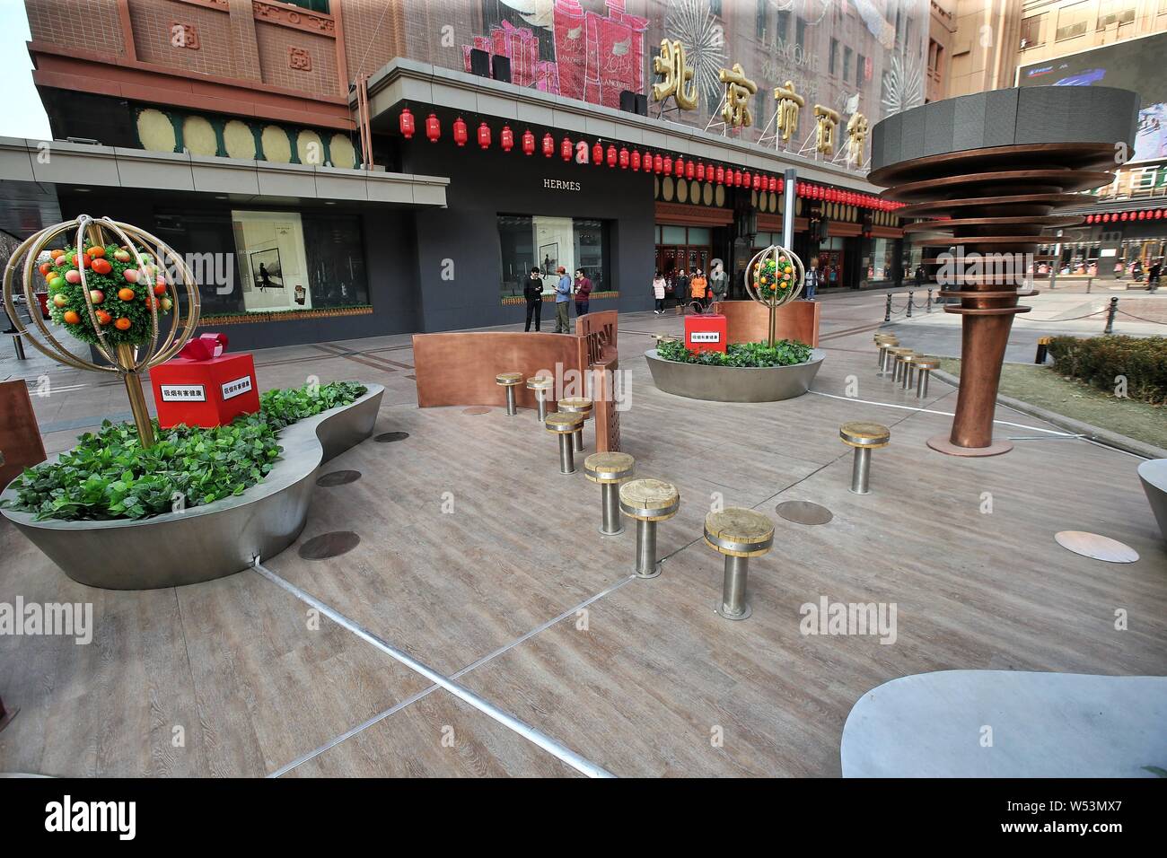 A large, open air smoking area featuring 18 stainless steel seats, 13 ...