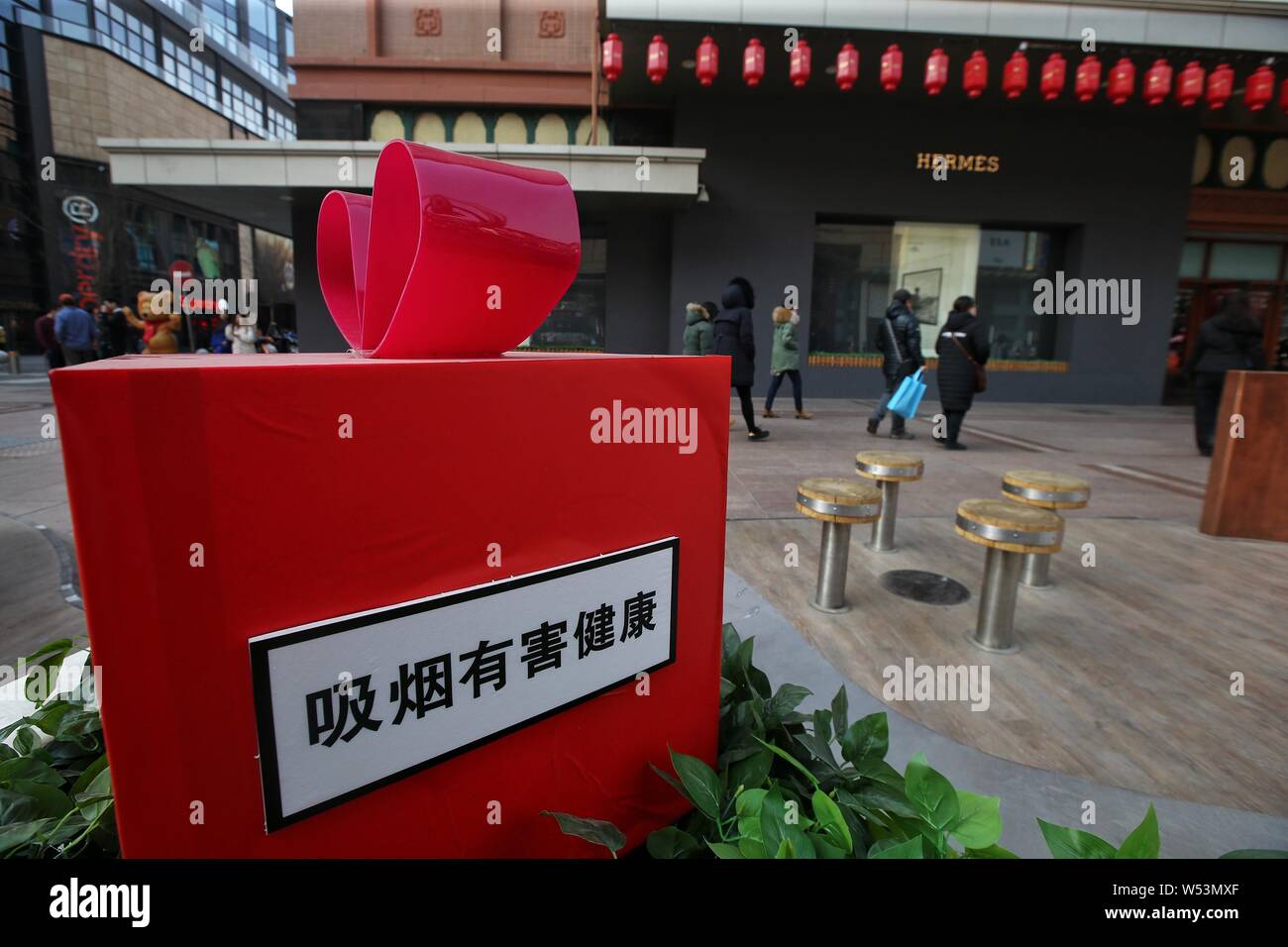 A large, open air smoking area featuring 18 stainless steel seats, 13 ...