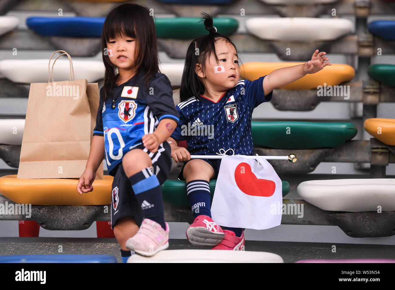 Japanese football fans wave their national flags to show support for ...