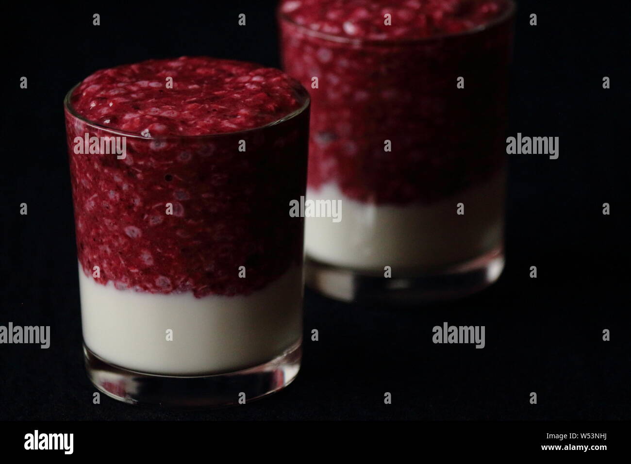 Raspberry parfait in glass with dark moody colors Stock Photo - Alamy