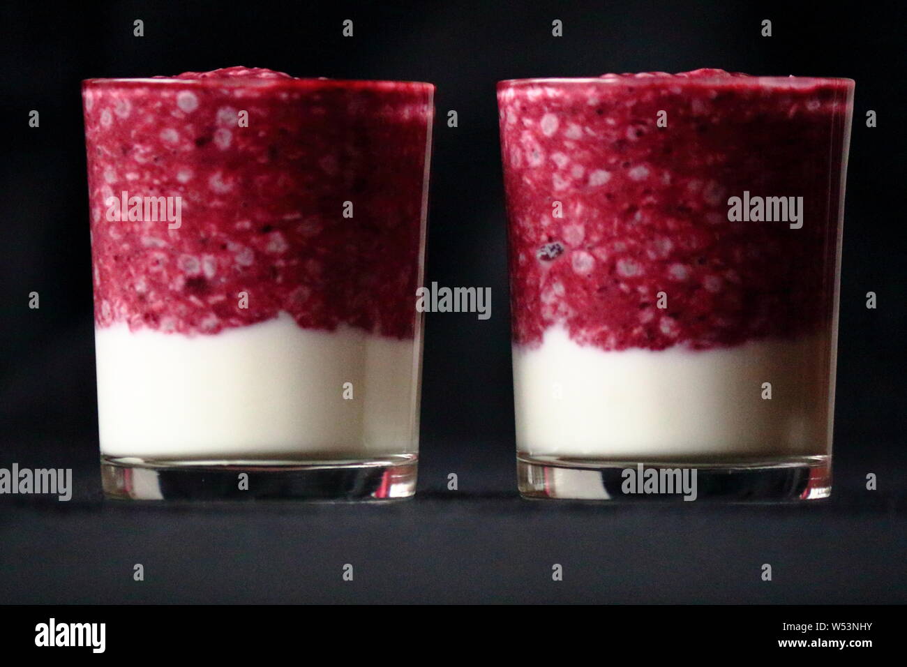 Raspberry parfait in glass with dark moody colors Stock Photo - Alamy