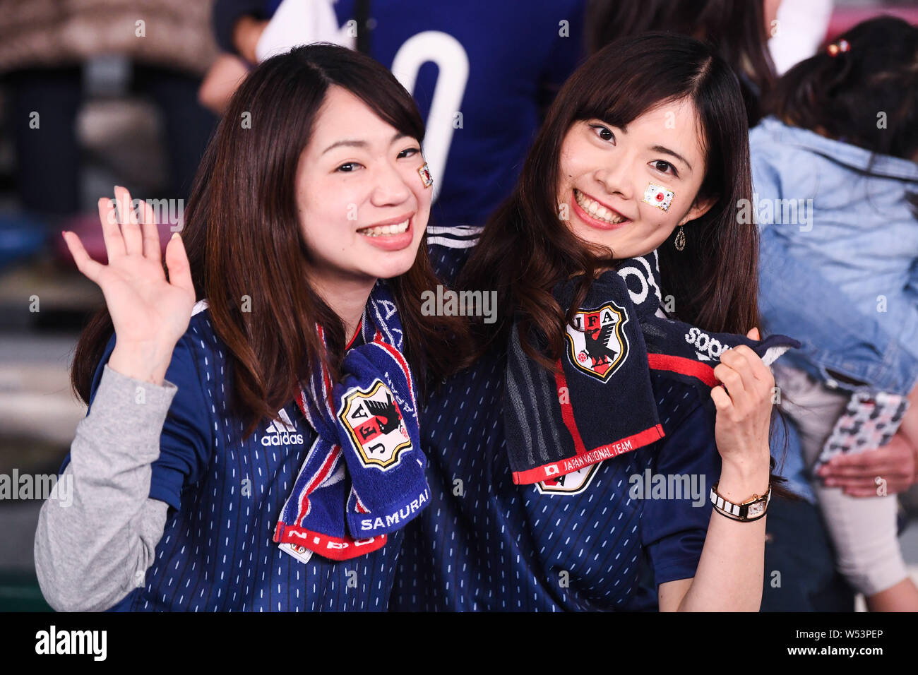 Japanese football fans wave their national flags to show support for ...