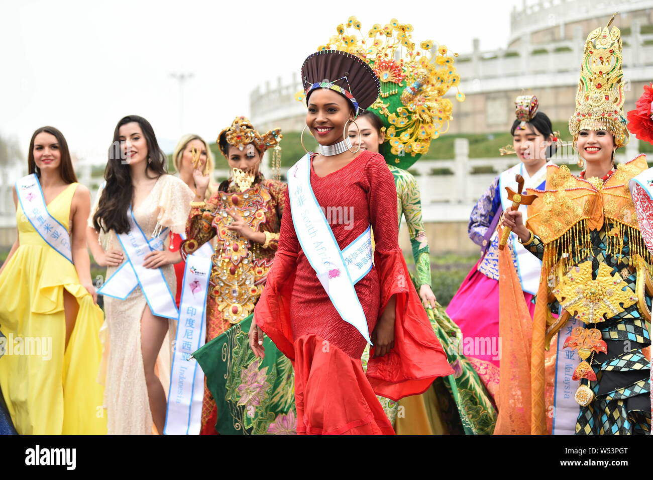 Contestants clad in traditional costumes or evening dresses take part ...
