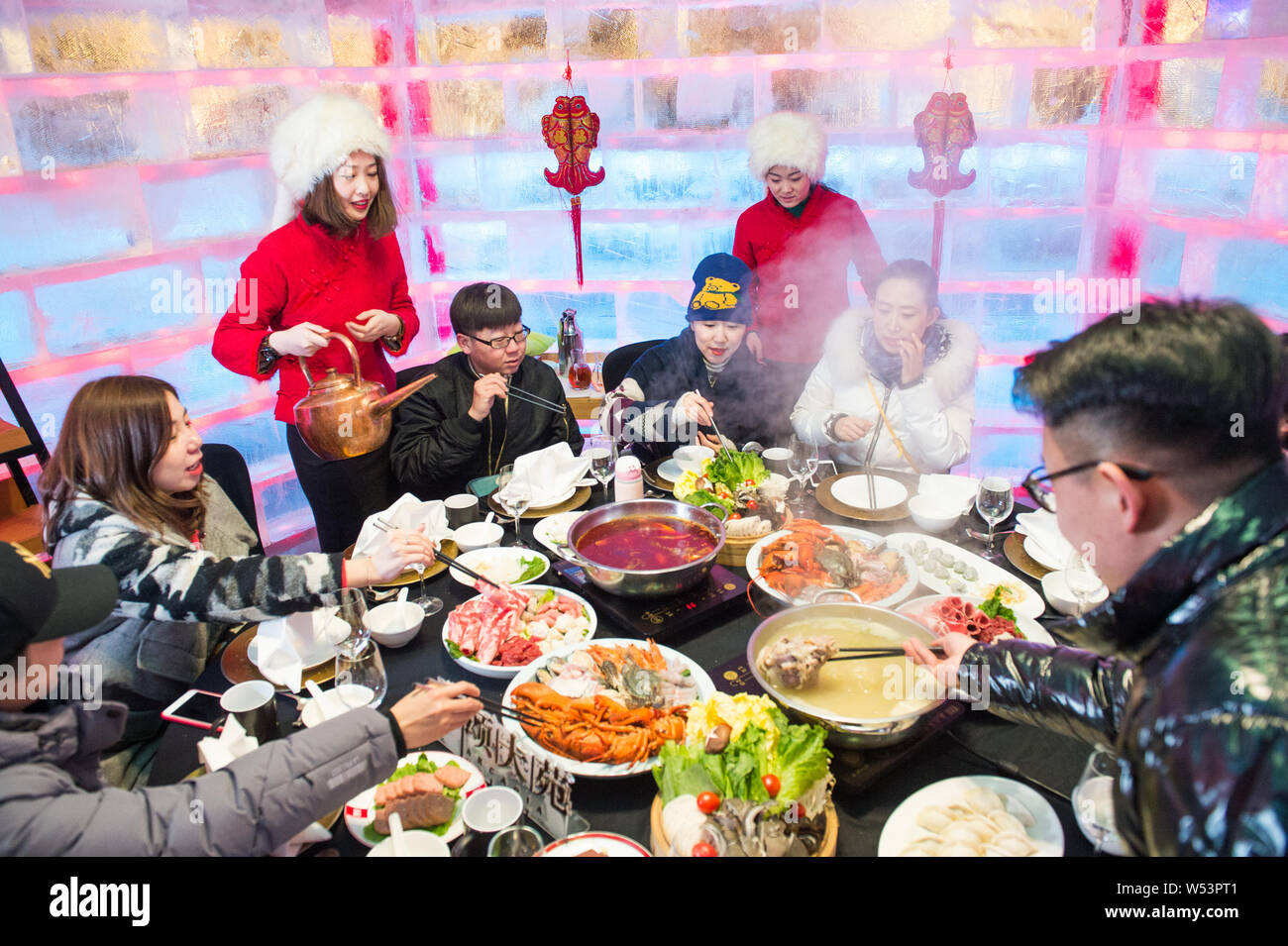 Chinese customers enjoy hot pot in an ice house built with ice blocks ...