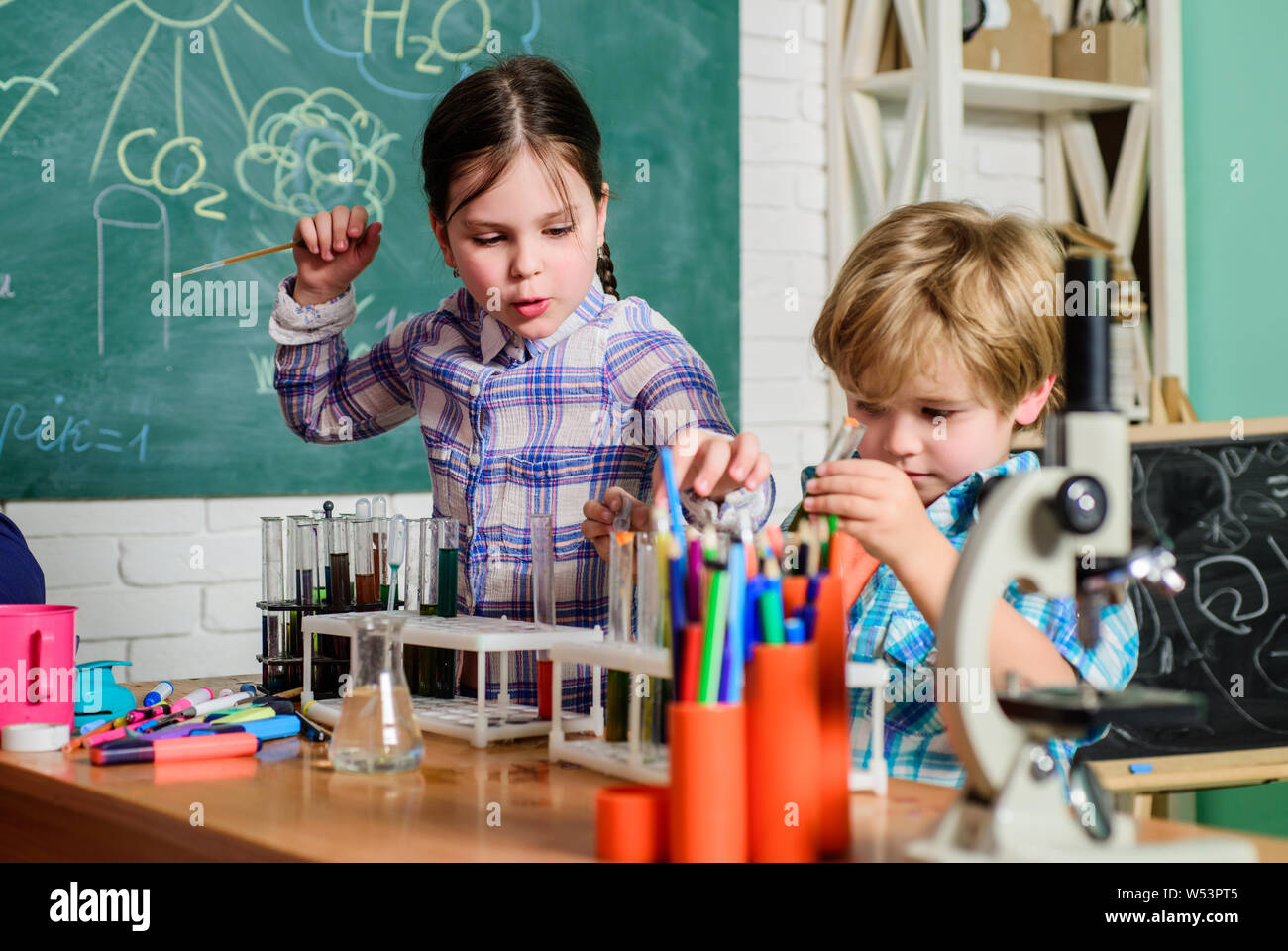 School club. Explaining chemistry to kid. Fascinating chemical reaction ...