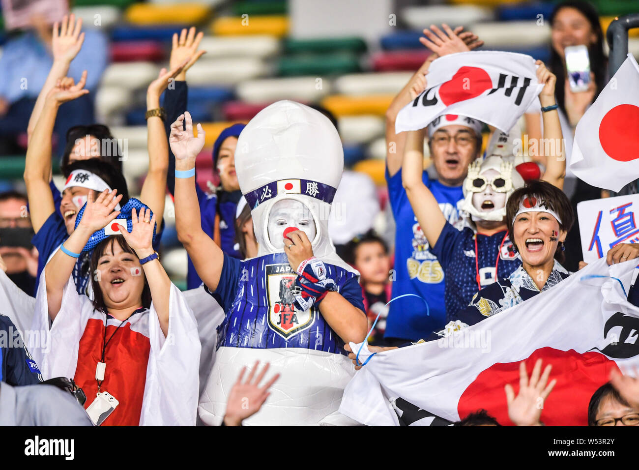 Japanese football fans wave their national flags to show support for ...