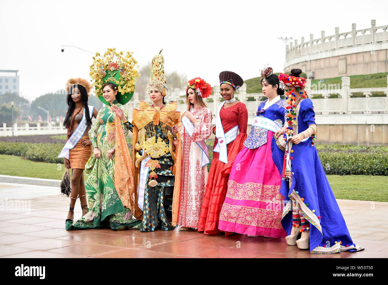 Contestants dressed in traditional costumes take part in an outdoor ...