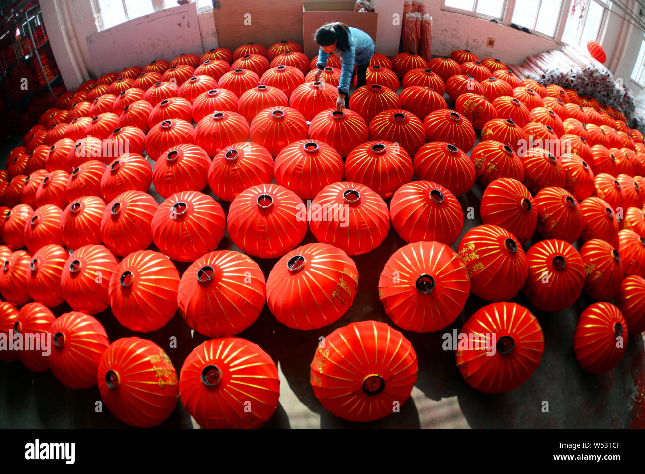 A Chinese worker makes red lanterns for the upcoming Spring Festival or ...