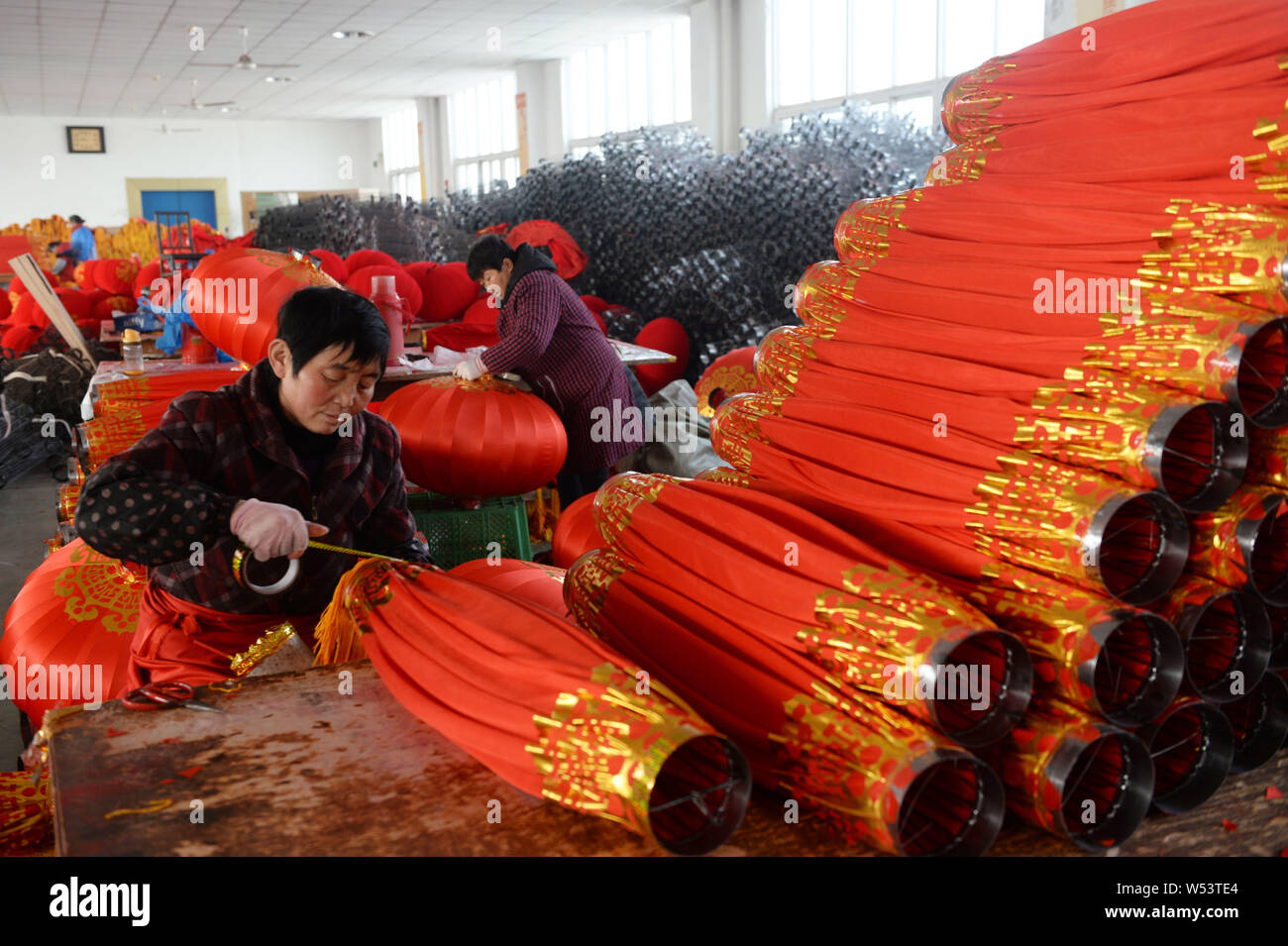 A Chinese worker makes red lanterns for the upcoming Spring Festival or ...