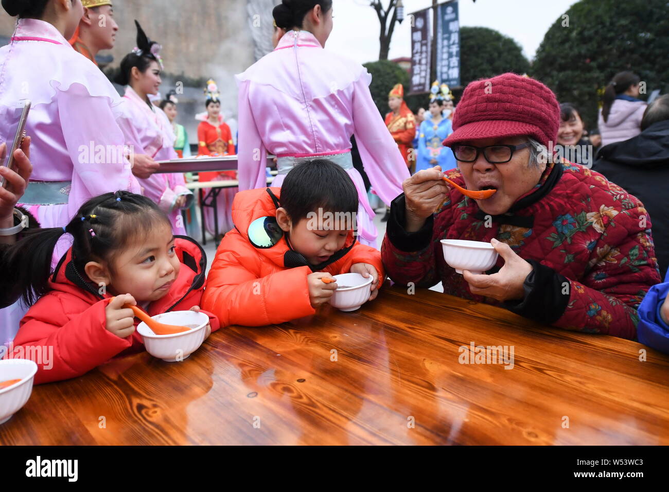 Visitors enjoy Laba Congee, or Eight Treasures Porridge, made by ...