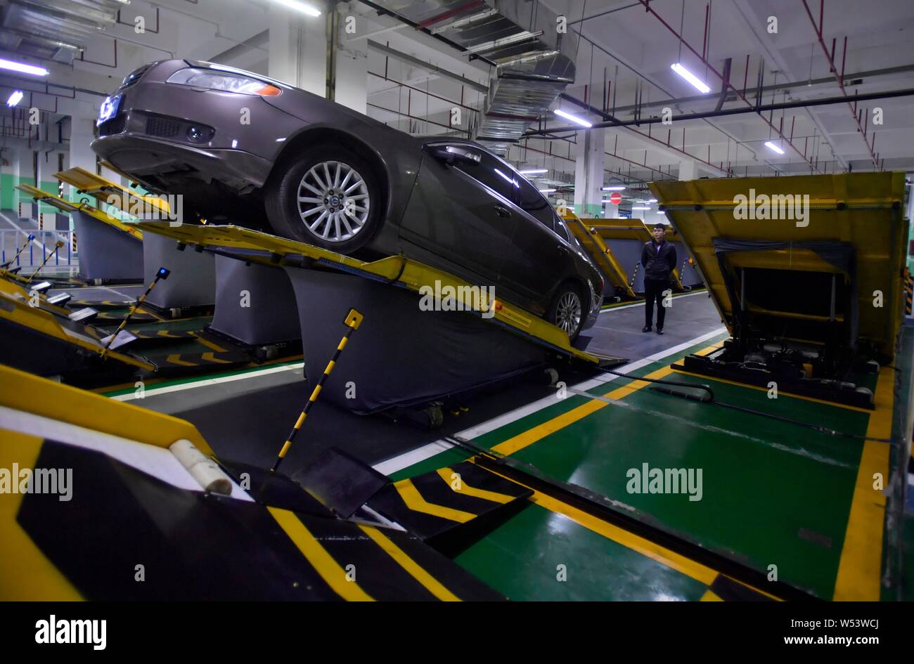 A local resident parks his car into an inclined position at a parking ...