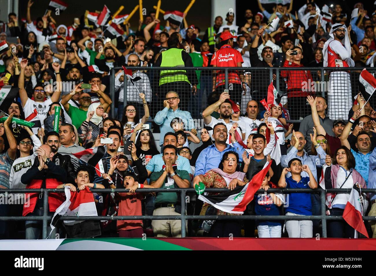 Iraqi football fans hold up their national flags to show support for ...