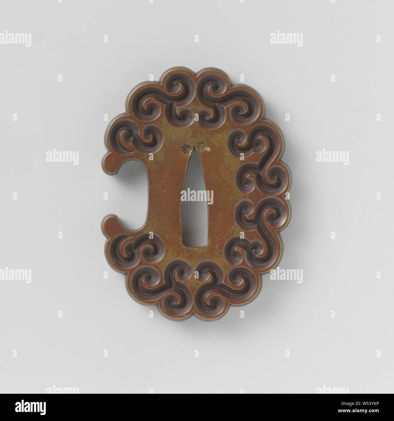 Hand guard, Oval lobed tsuba in front of a dagger with an open hitu ...