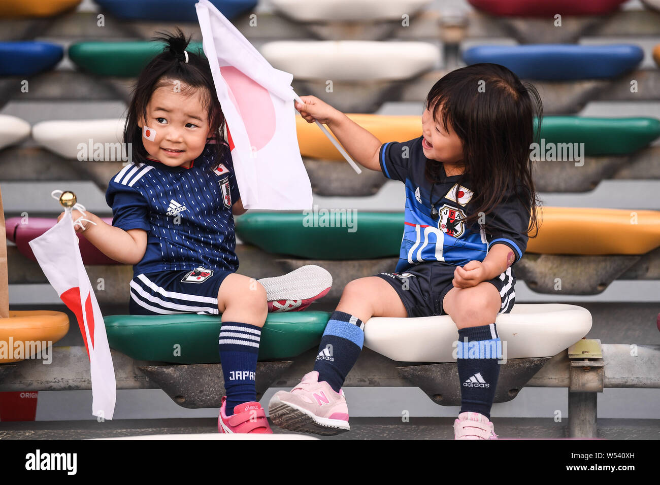 Japanese football fans wave their national flags to show support for ...